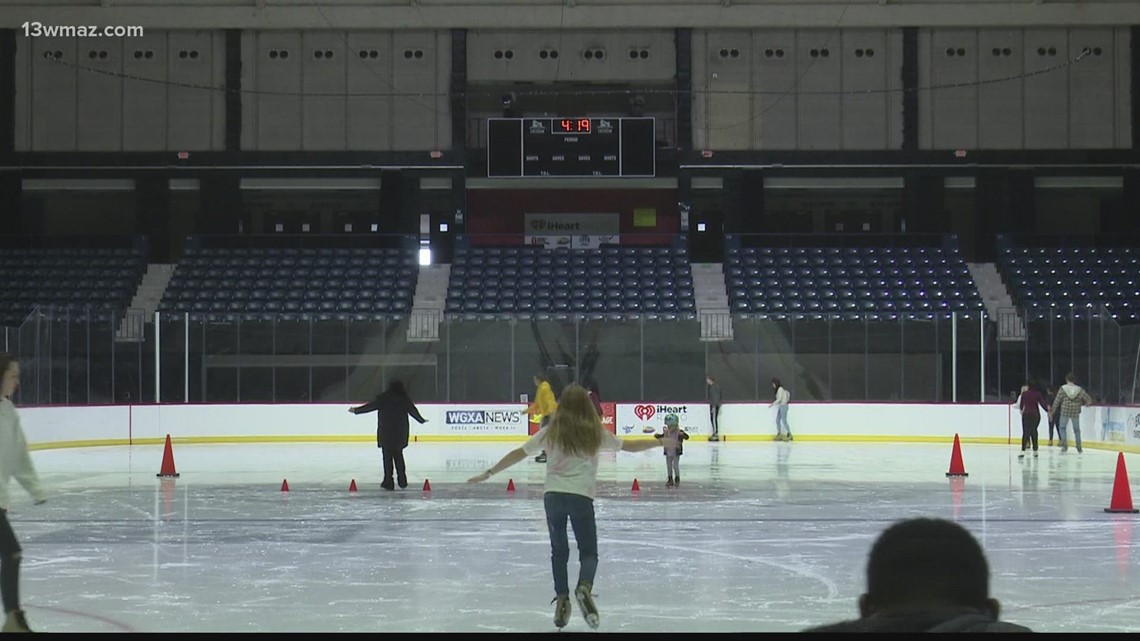 Skaters learn from an expert during free public skating at the Macon ...